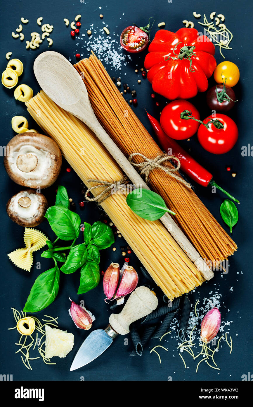 Italian ingredients - pasta, vegetables, spices, cheese - on dark ...