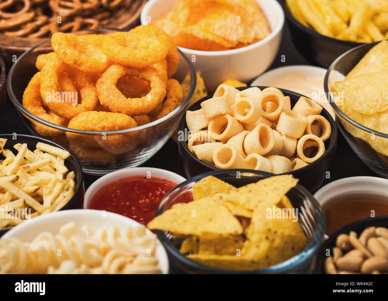 All classic potato snacks with peanuts, popcorn and onion rings and ...