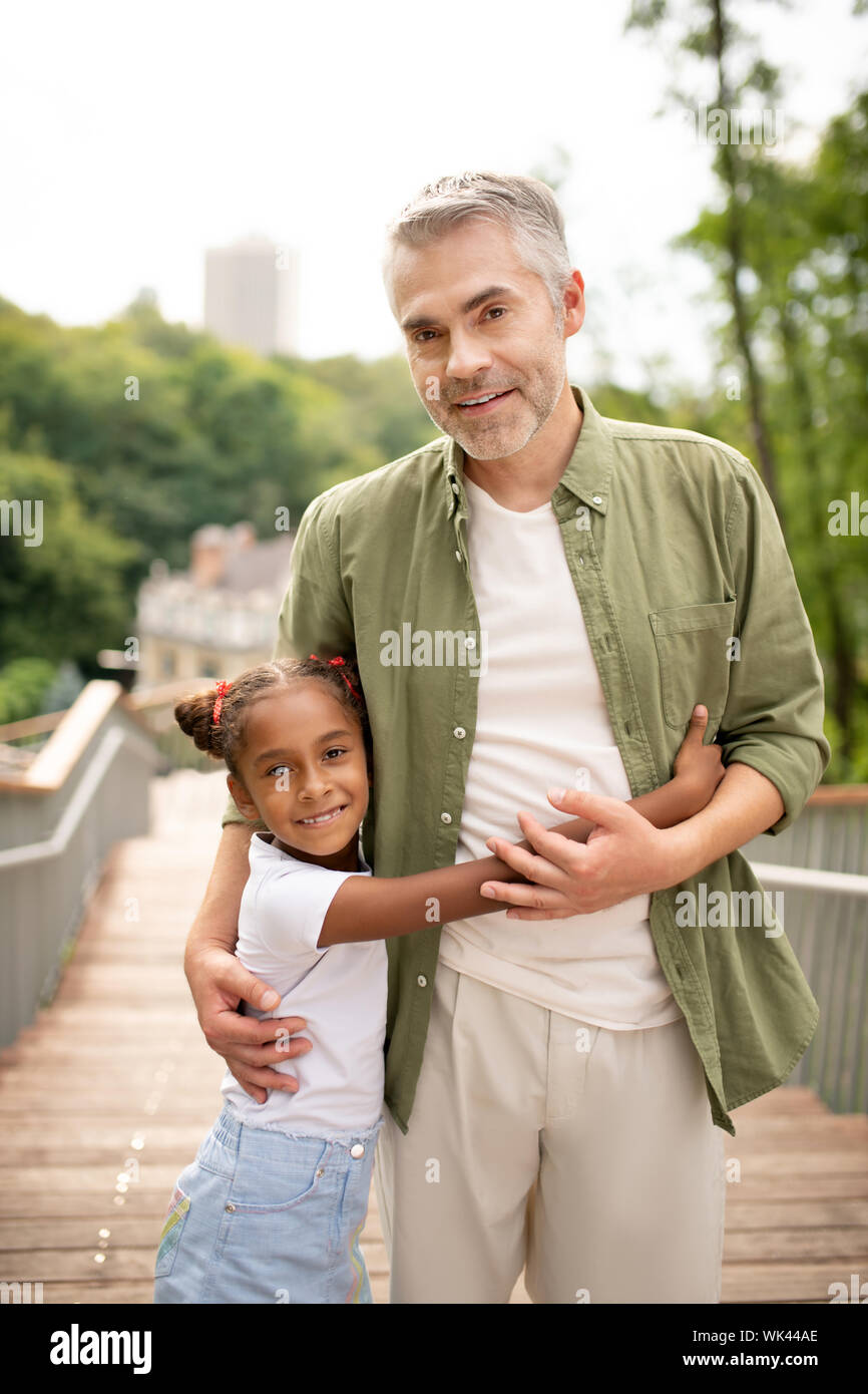 Grey-haired father feeling relieved spending time with daughter Stock ...