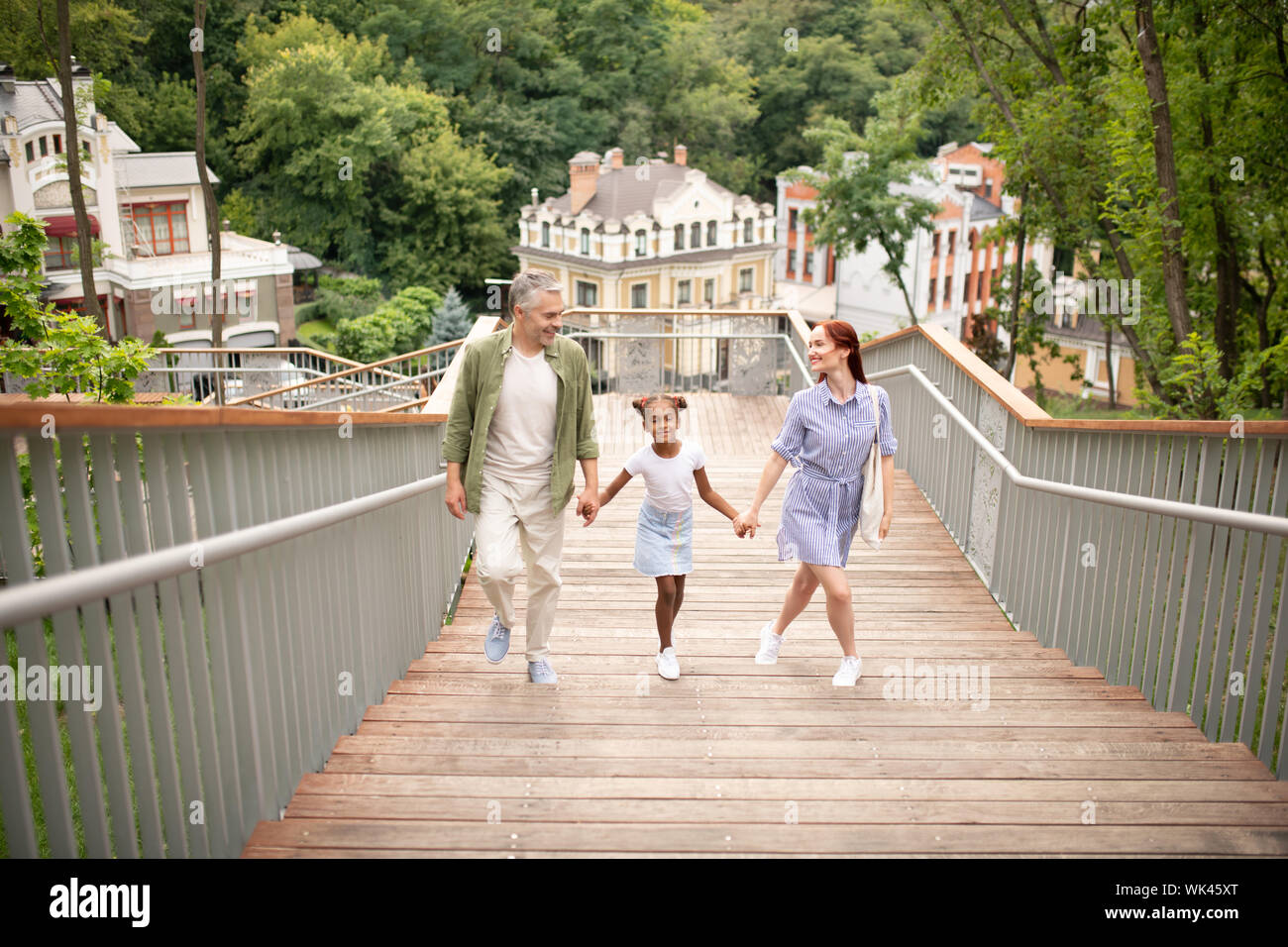 Family walking upstairs while spending time together Stock Photo - Alamy