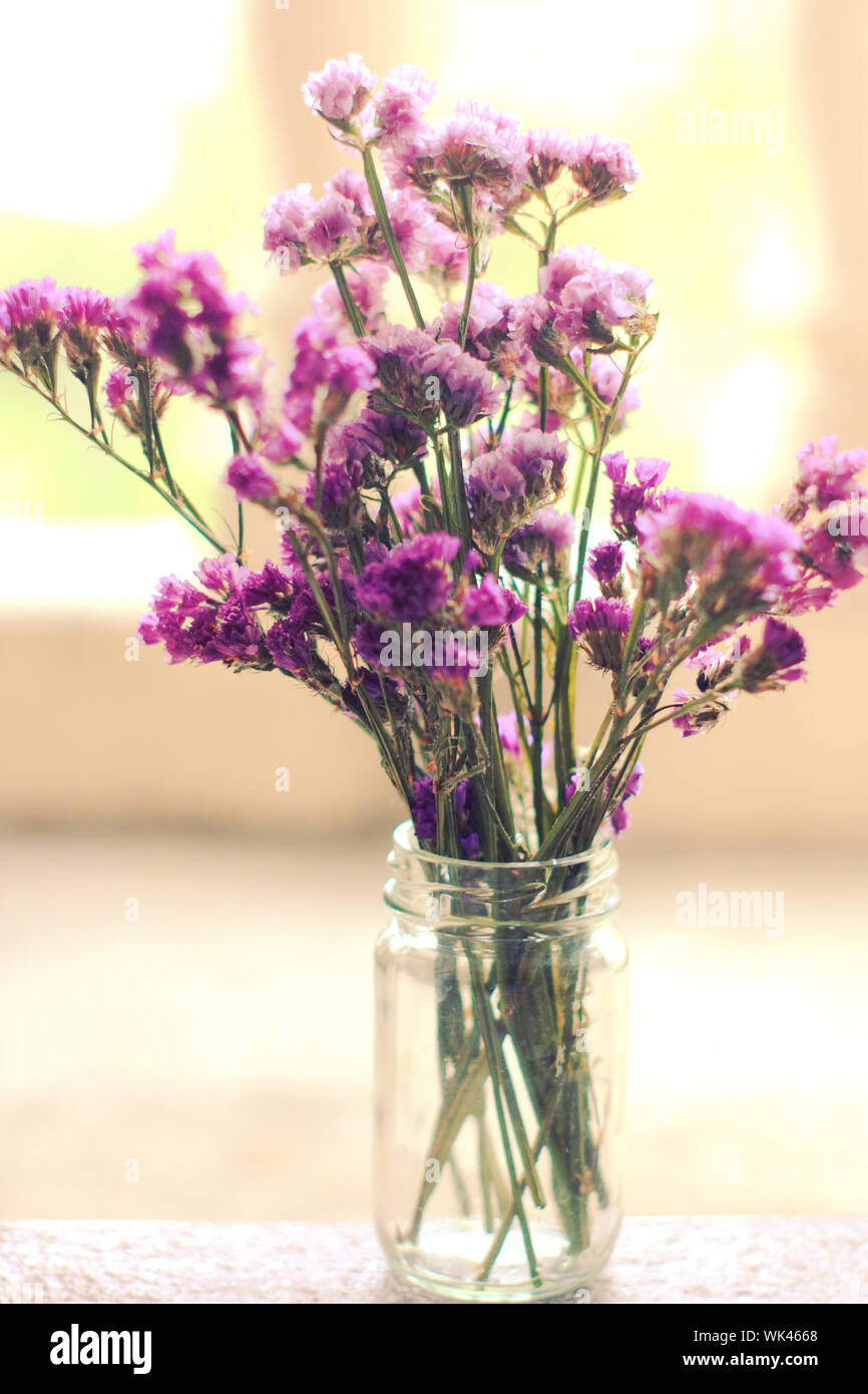 Bouquet of statice flowers arrangement in glass with retro filter ...