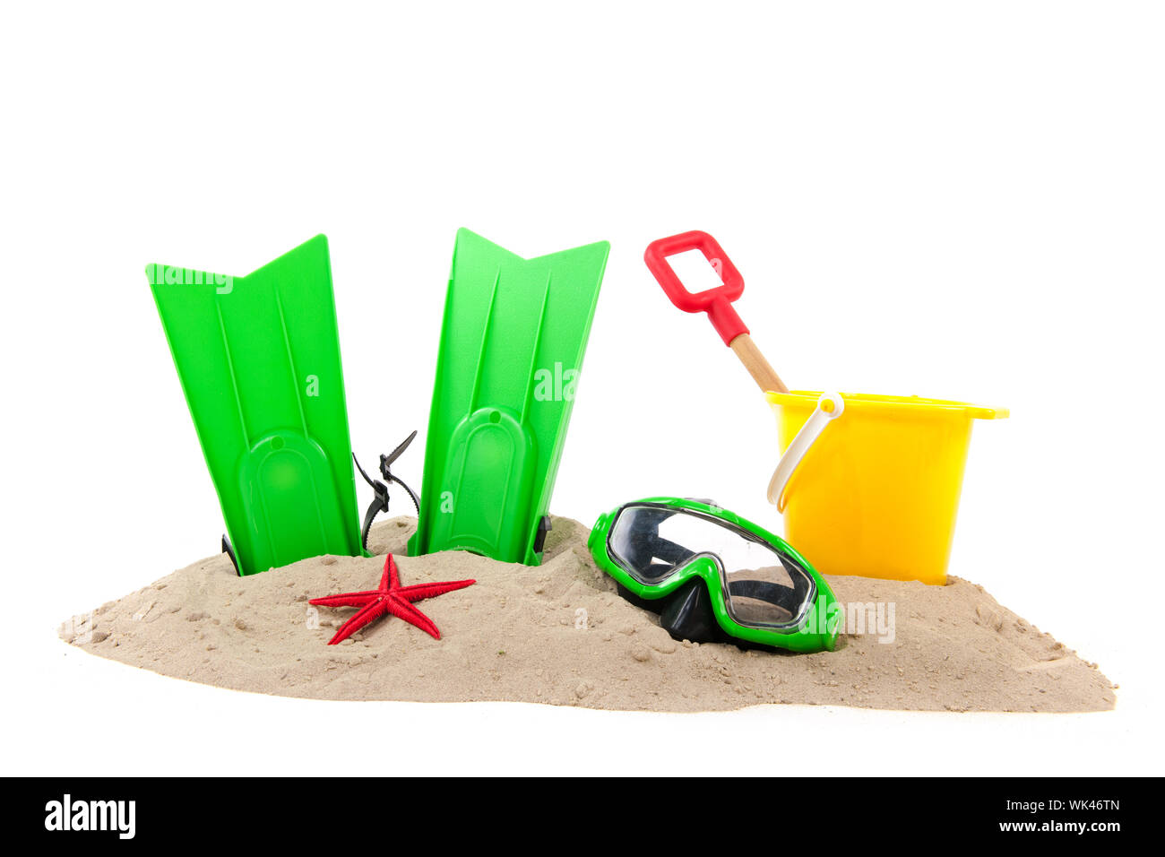 Beach with green diving equipment and yellow bucket Stock Photo - Alamy