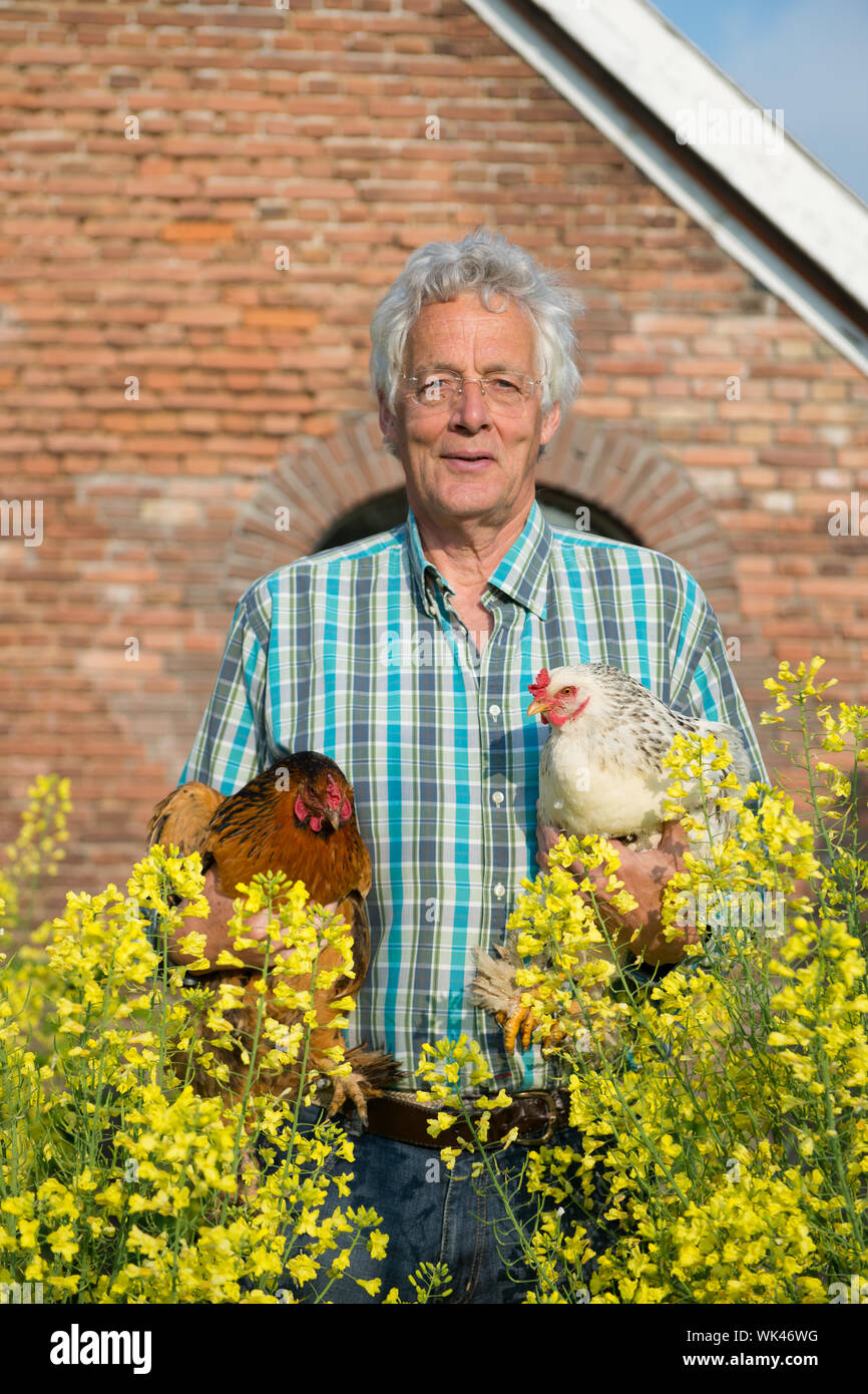 Farmer outdoor is carrying chickens Stock Photo - Alamy
