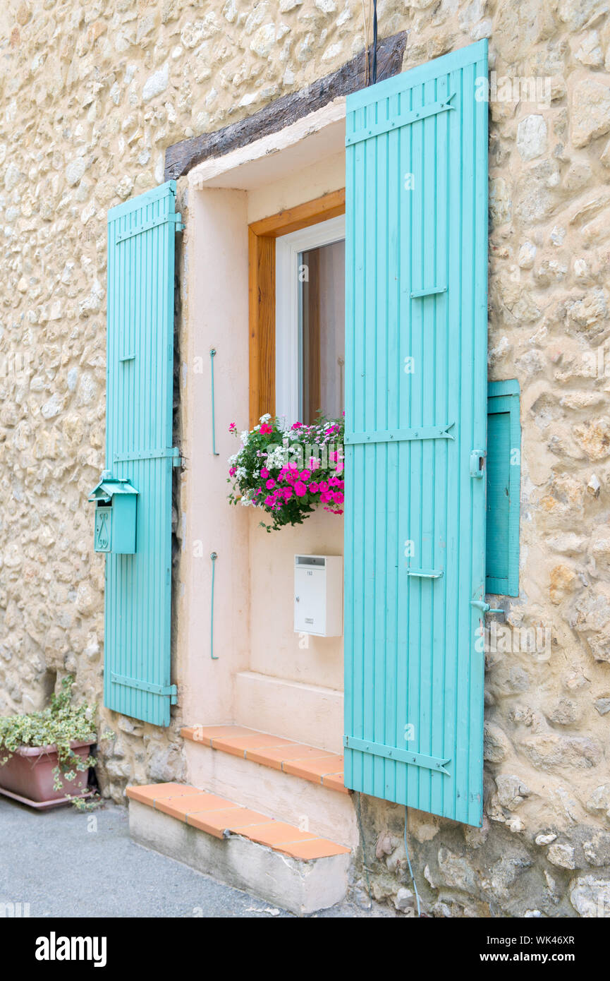 French window with typical pink flowers and green blue shutters Stock ...