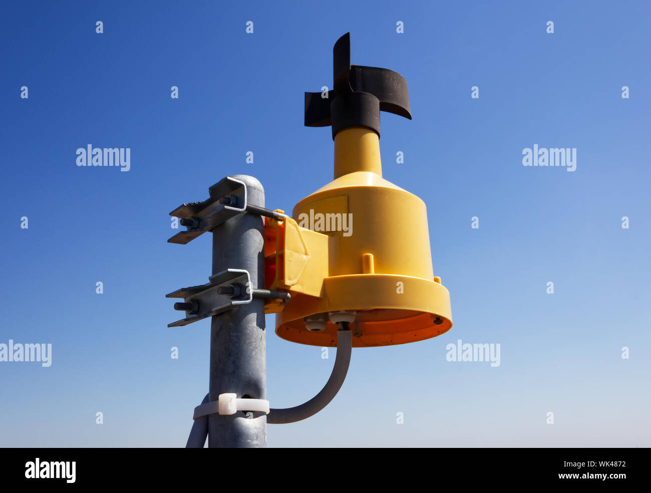 Wind speed measuring device on display. Anemometer on blue background ...