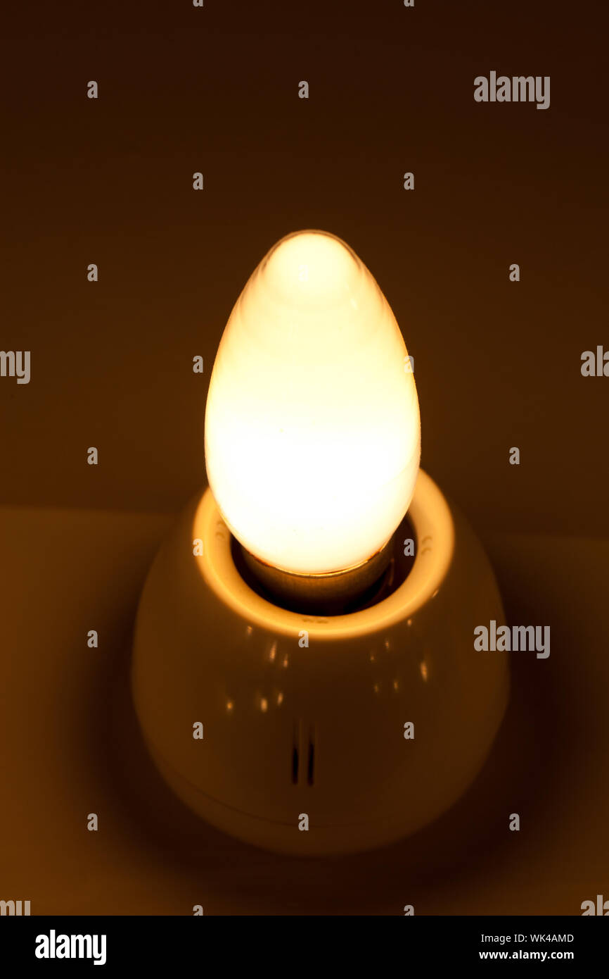 Illuminated light bulb in a room Stock Photo - Alamy