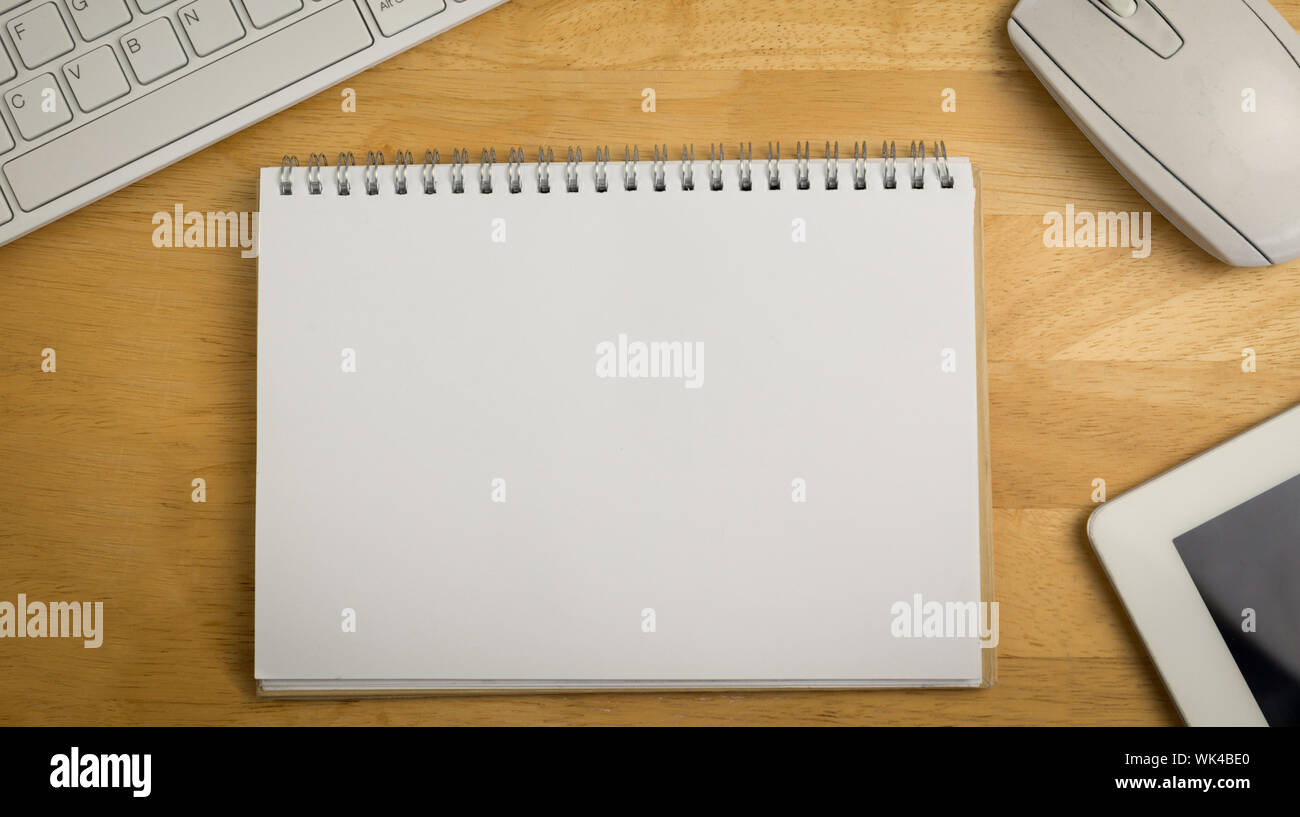 Overhead of notepad and technology on a desk Stock Photo - Alamy