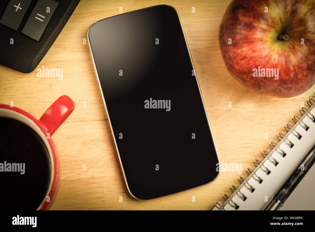 Overhead of smartphone screen on a cluttered desk Stock Photo - Alamy