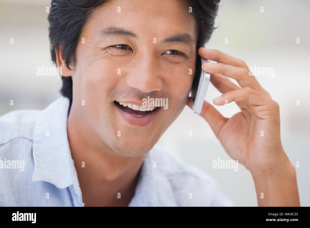 Happy man on a phone call outside on a balcony Stock Photo - Alamy