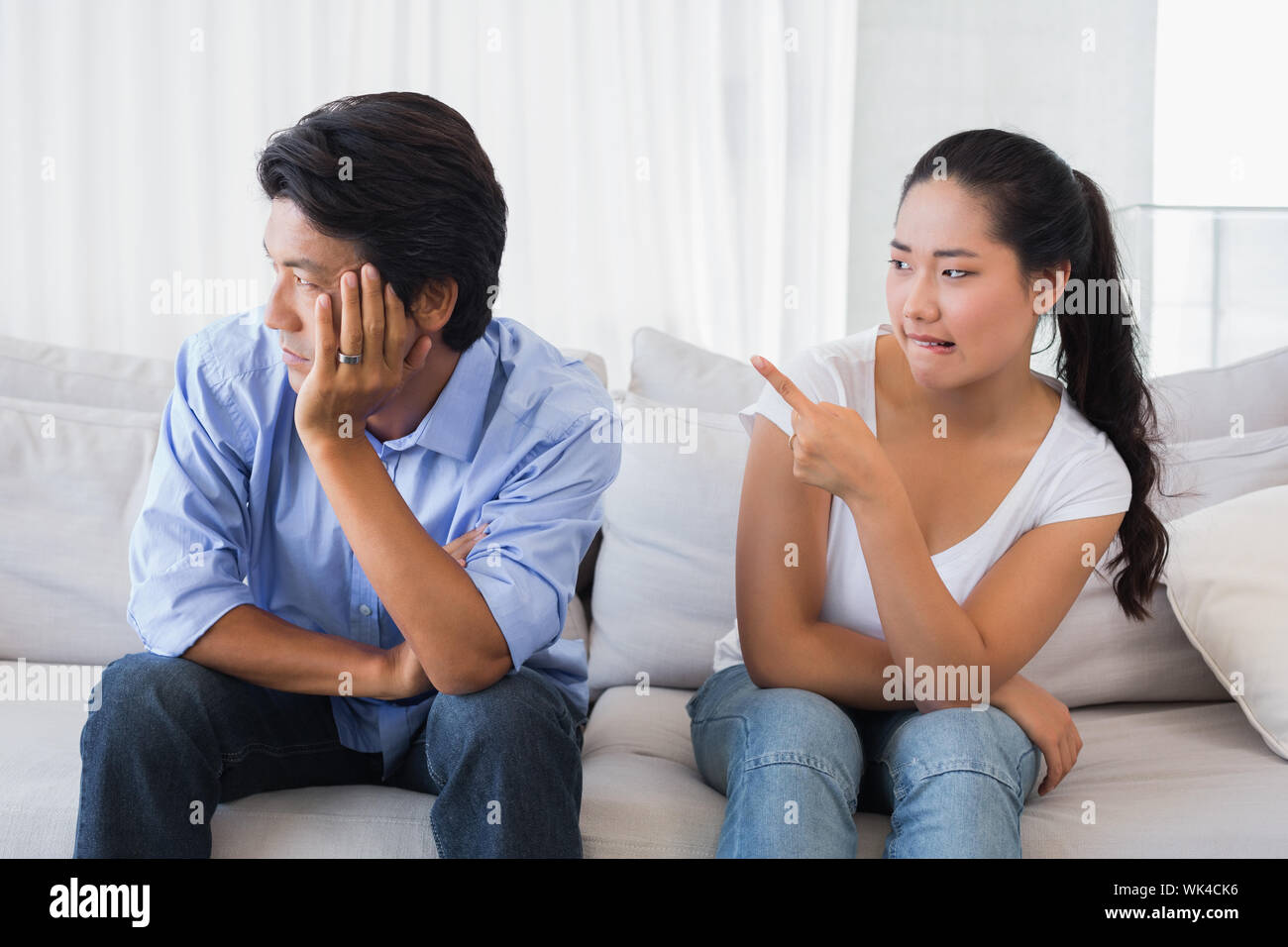 Couple having a dispute on the sofa at home in the living room Stock ...