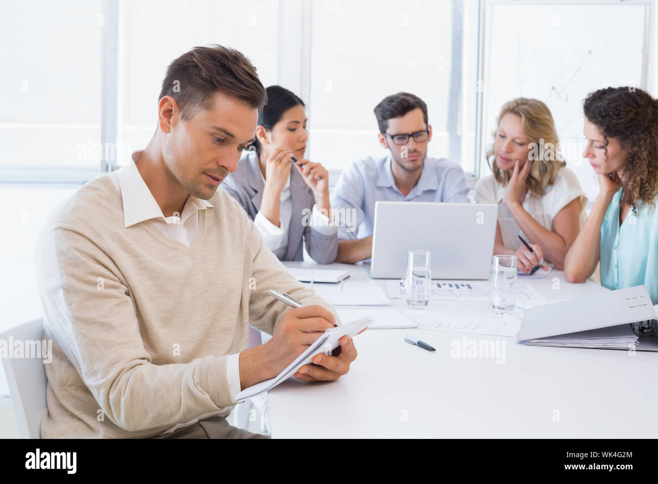 Casual businessman taking notes during meeting in the office Stock ...