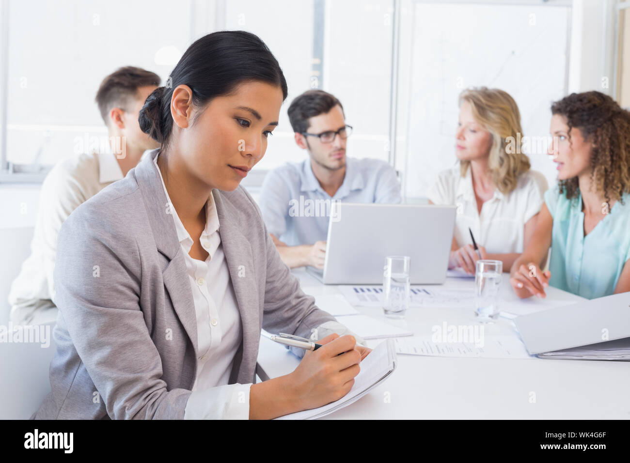 Casual businesswoman taking notes during meeting in the office Stock ...