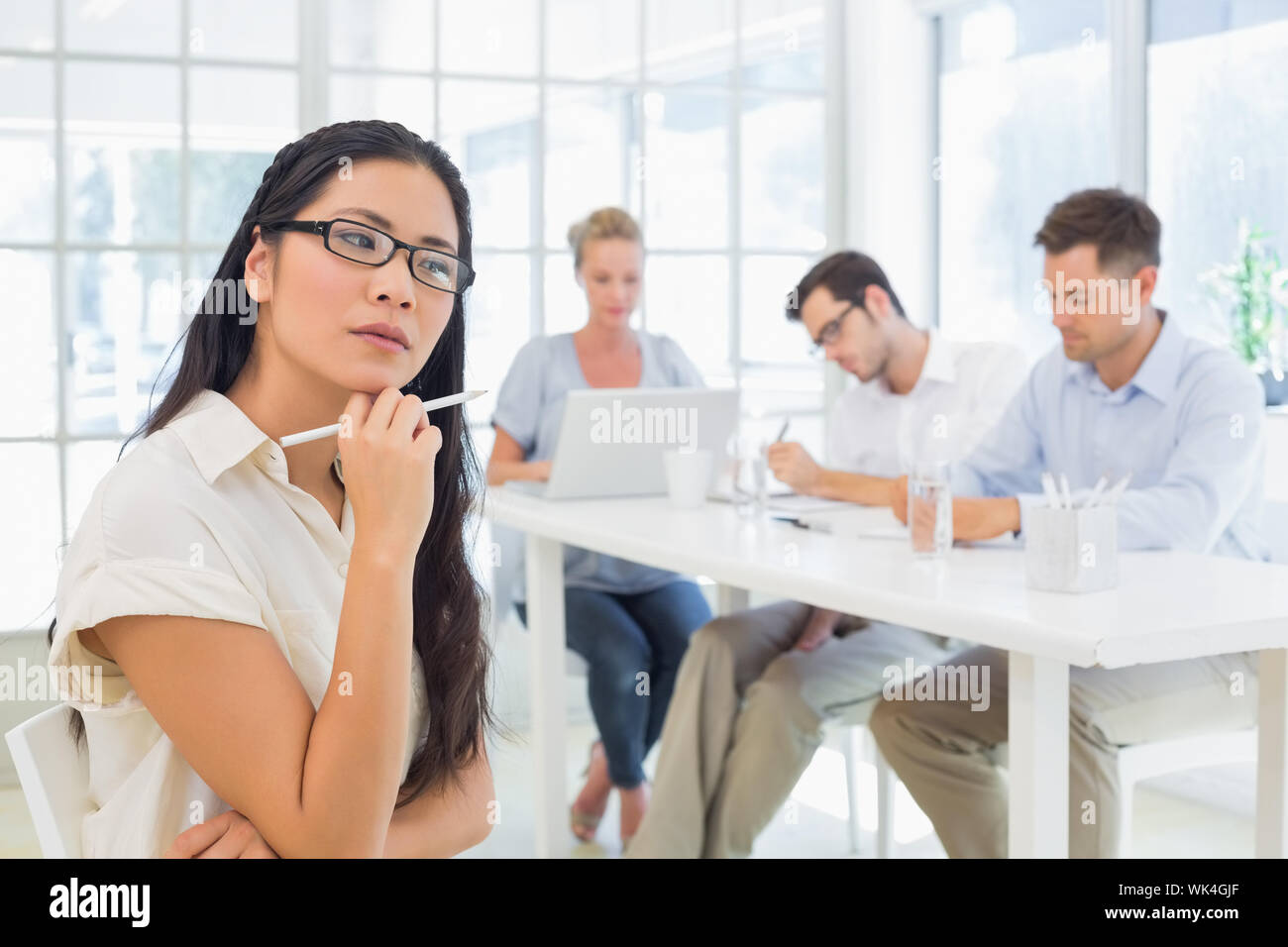 Casual businesswoman thinking during a meeting in the office Stock ...