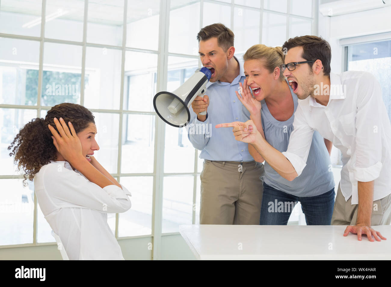 Casual business team shouting at a colleague in the office Stock Photo ...