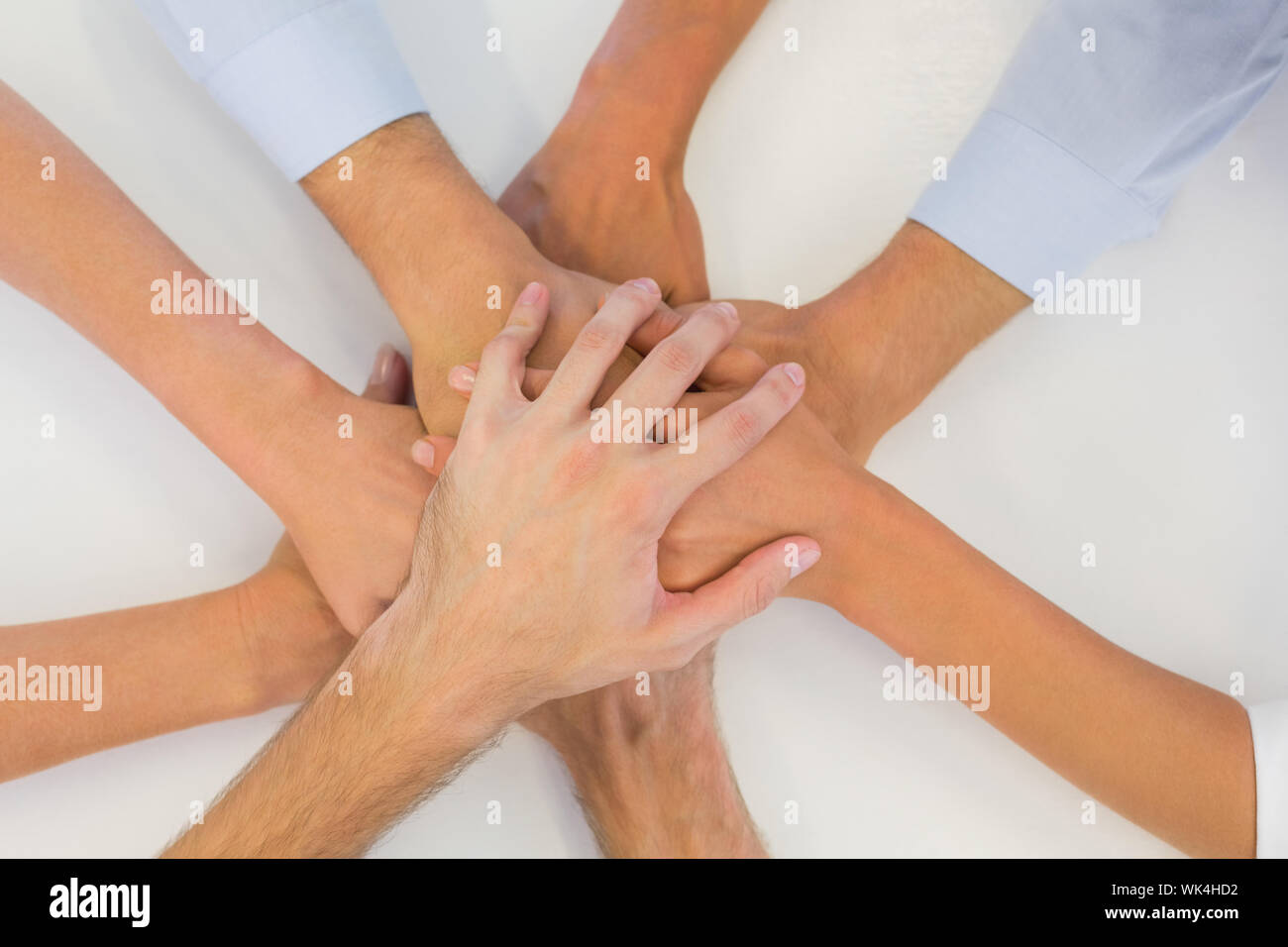 Business team putting their hands together in the office Stock Photo ...