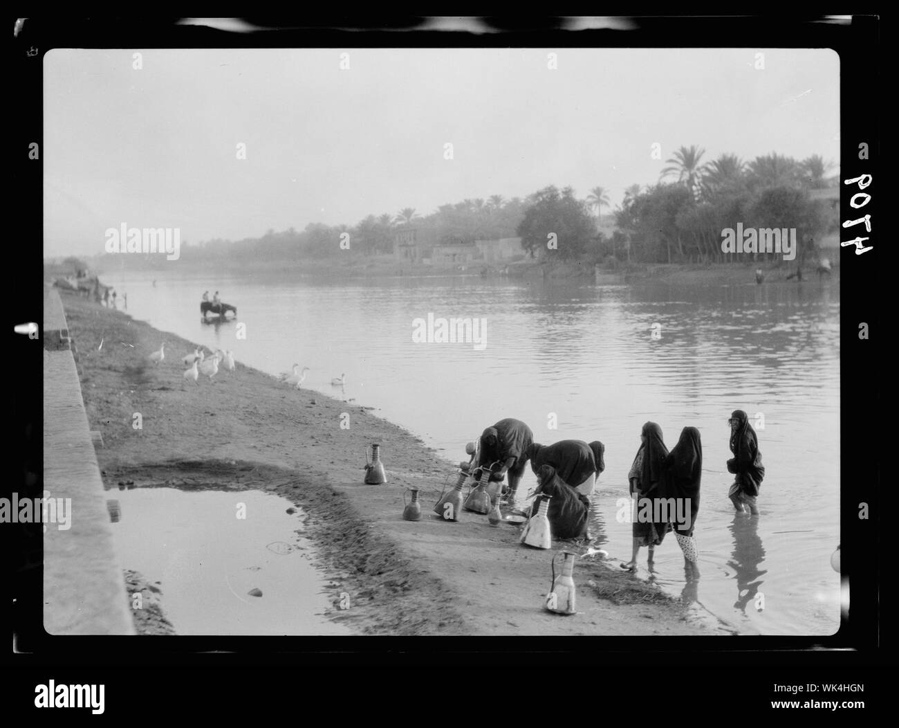 Iraq. River scenes on the Euphrates taken at Hilla. Women with copper ...