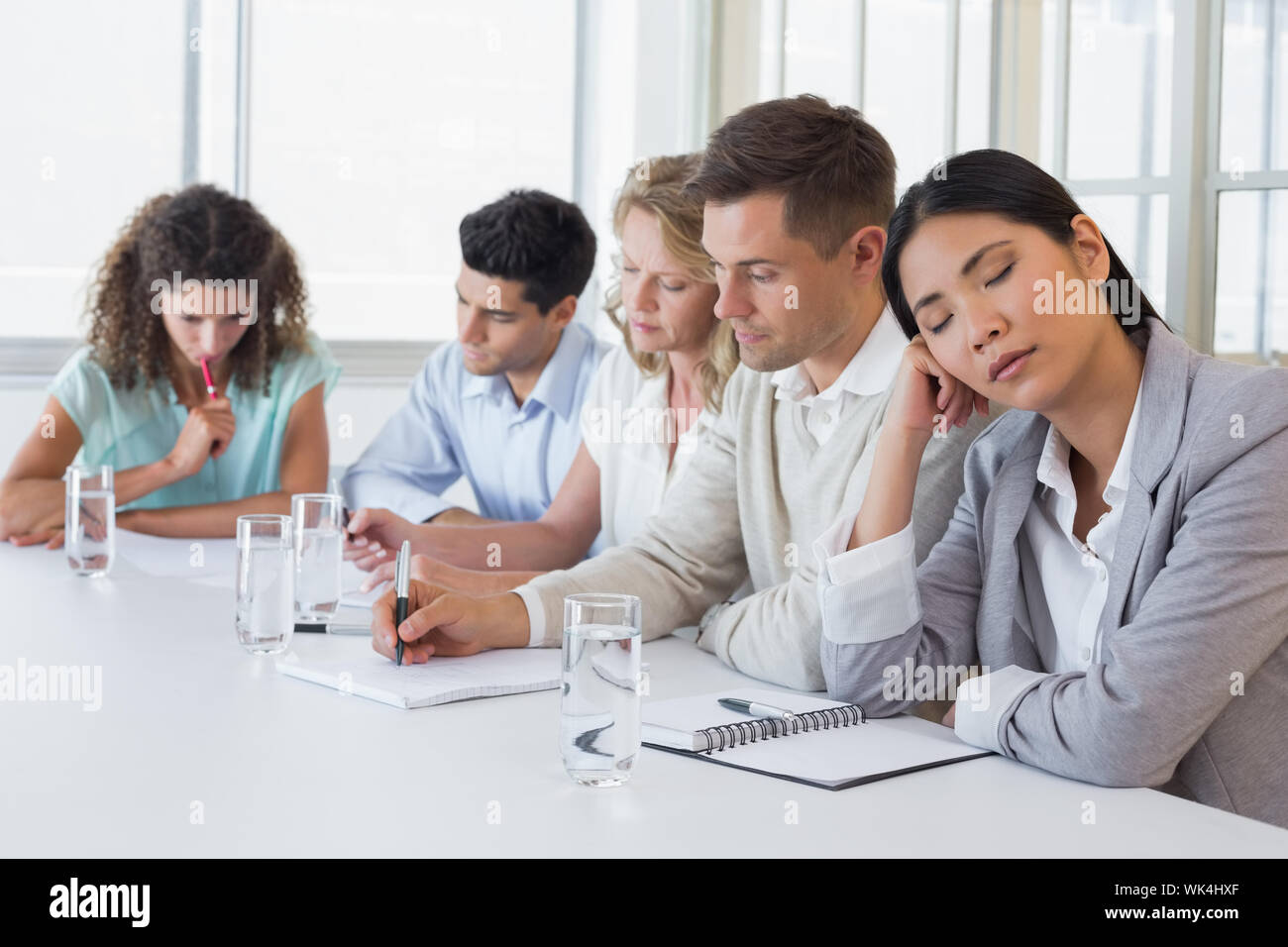 Casual businesswoman falling asleep during meeting in the office Stock ...
