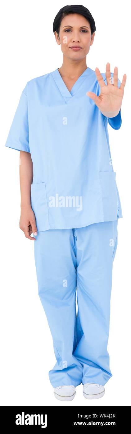 Pretty dark haired surgeon gesturing on white background Stock Photo ...