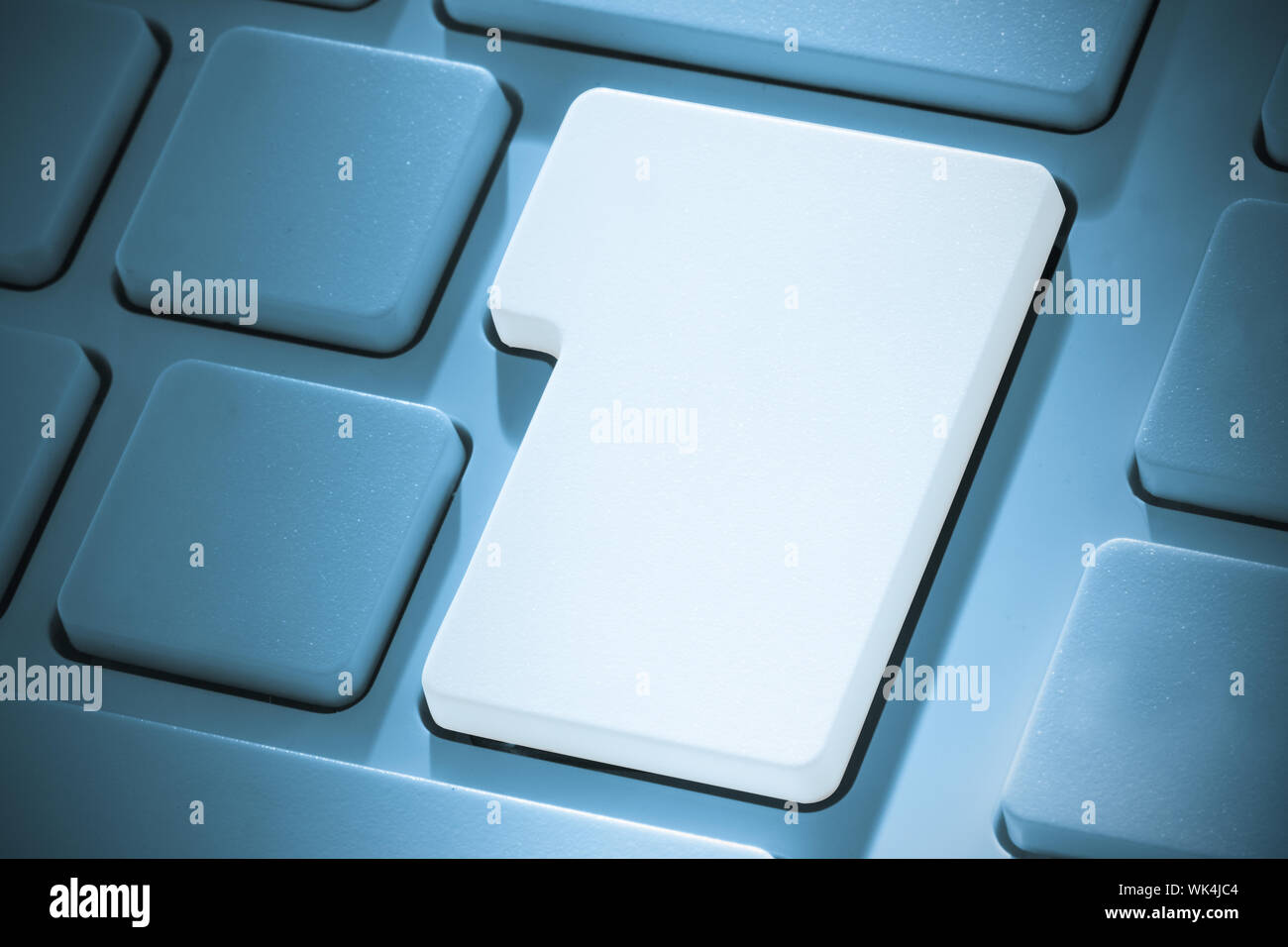 White enter key on blue keyboard Stock Photo - Alamy