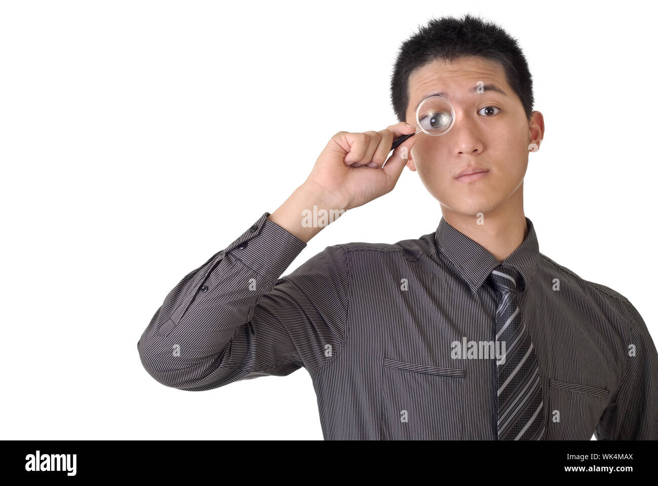 Handsome business man of Asian holding magnifier on white background ...