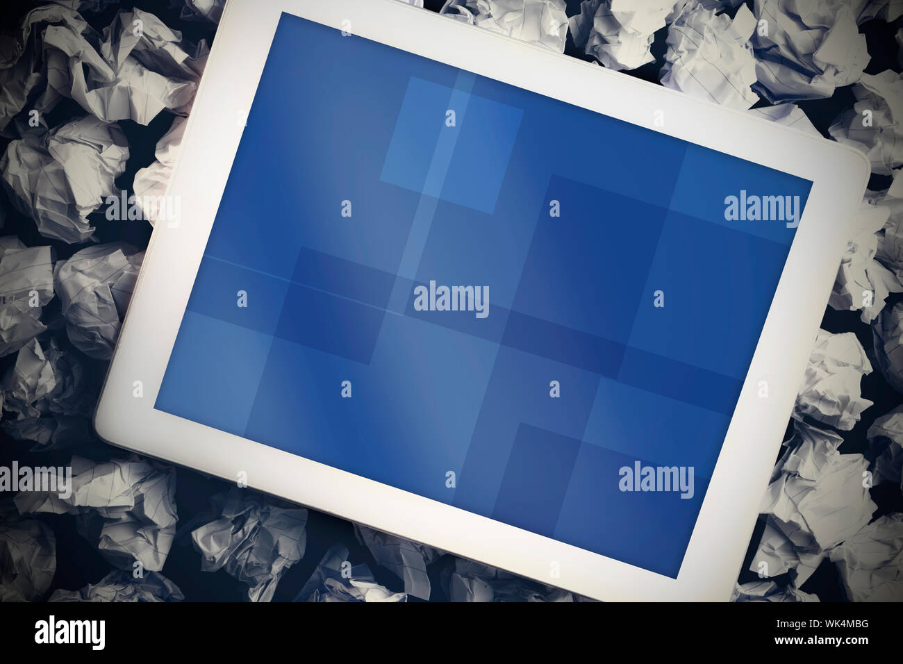 Tablet pc with blue screen on crumpled paper Stock Photo - Alamy