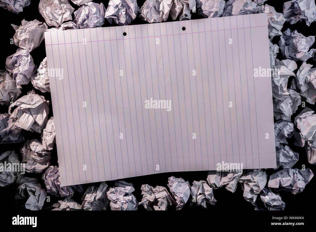 Lined paper notebook on crumpled paper on dark background Stock Photo ...