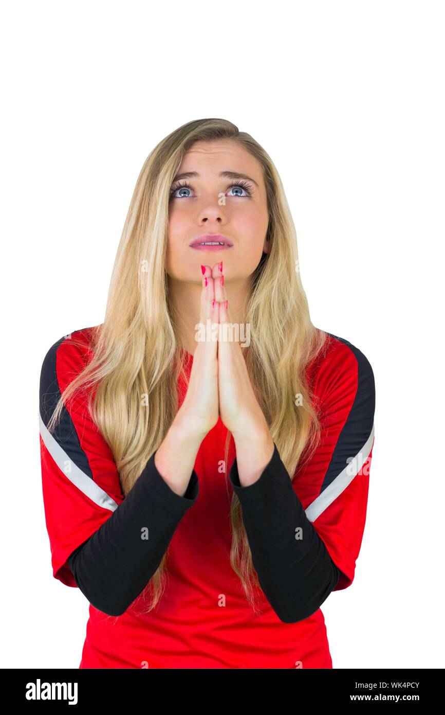 Nervous football fan in red on white background Stock Photo - Alamy