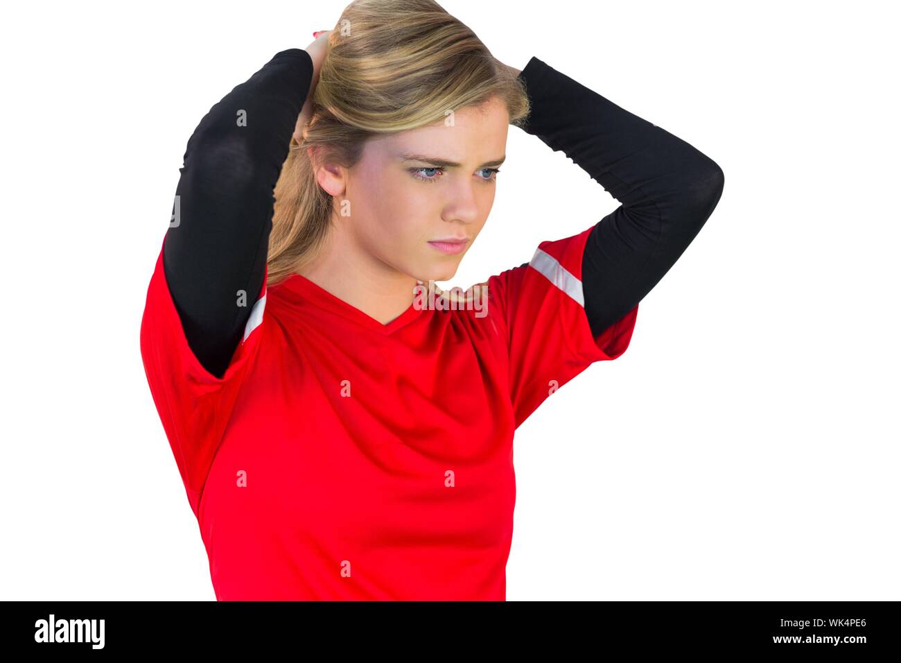 Disappointed football fan in red on white background Stock Photo - Alamy