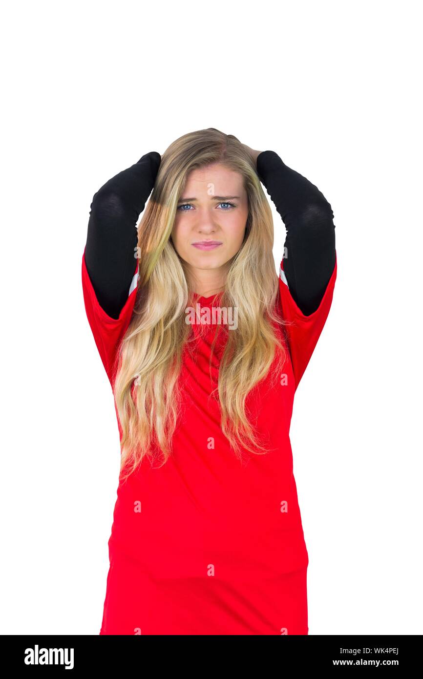 Disappointed football fan in red on white background Stock Photo - Alamy