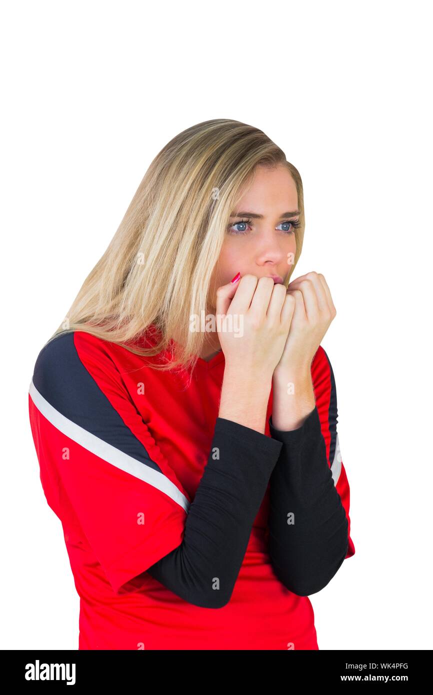 Nervous football fan in red on white background Stock Photo - Alamy