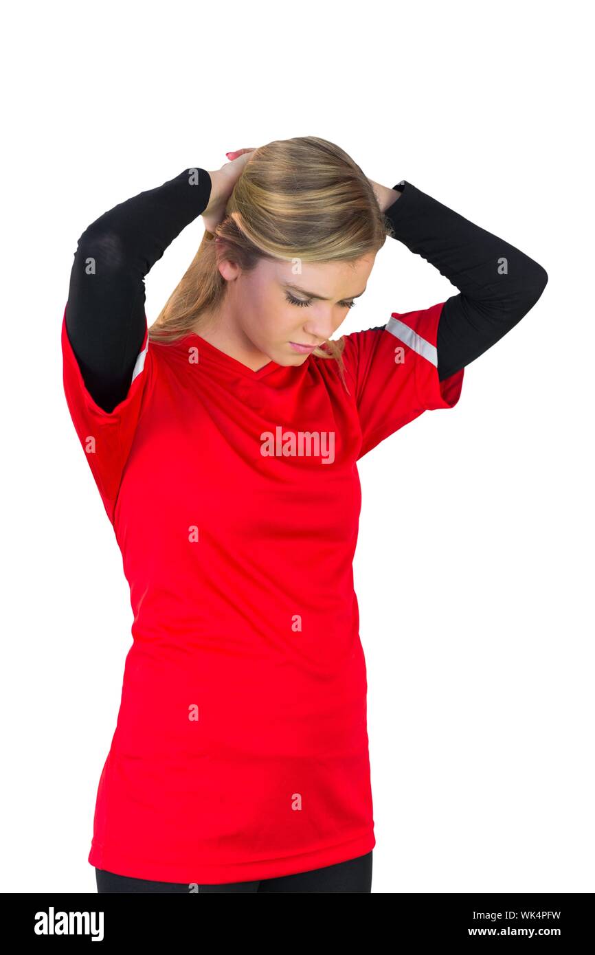 Disappointed football fan in red on white background Stock Photo - Alamy