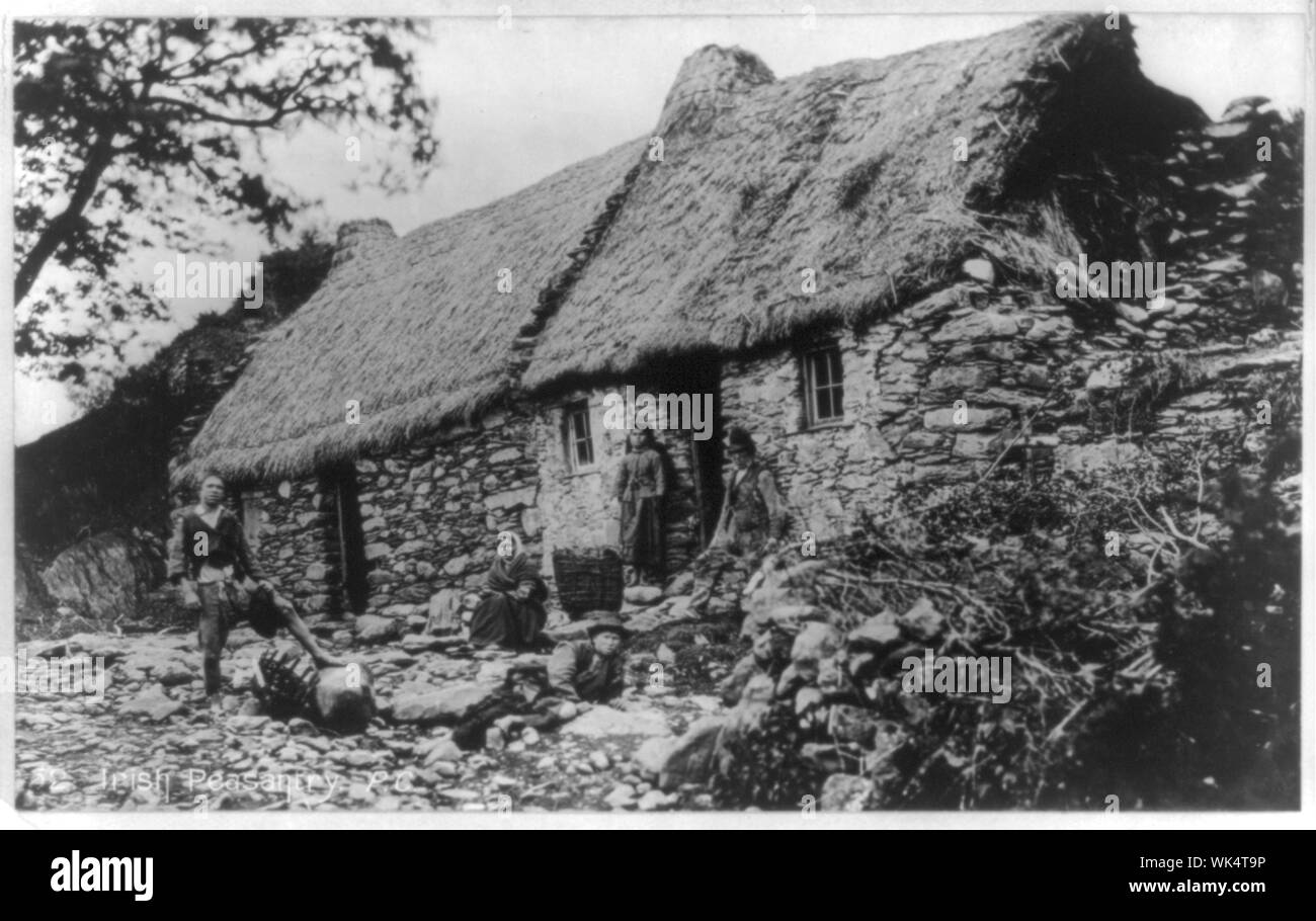 Irish family in front of peasant house with thatched roof, Ireland ...