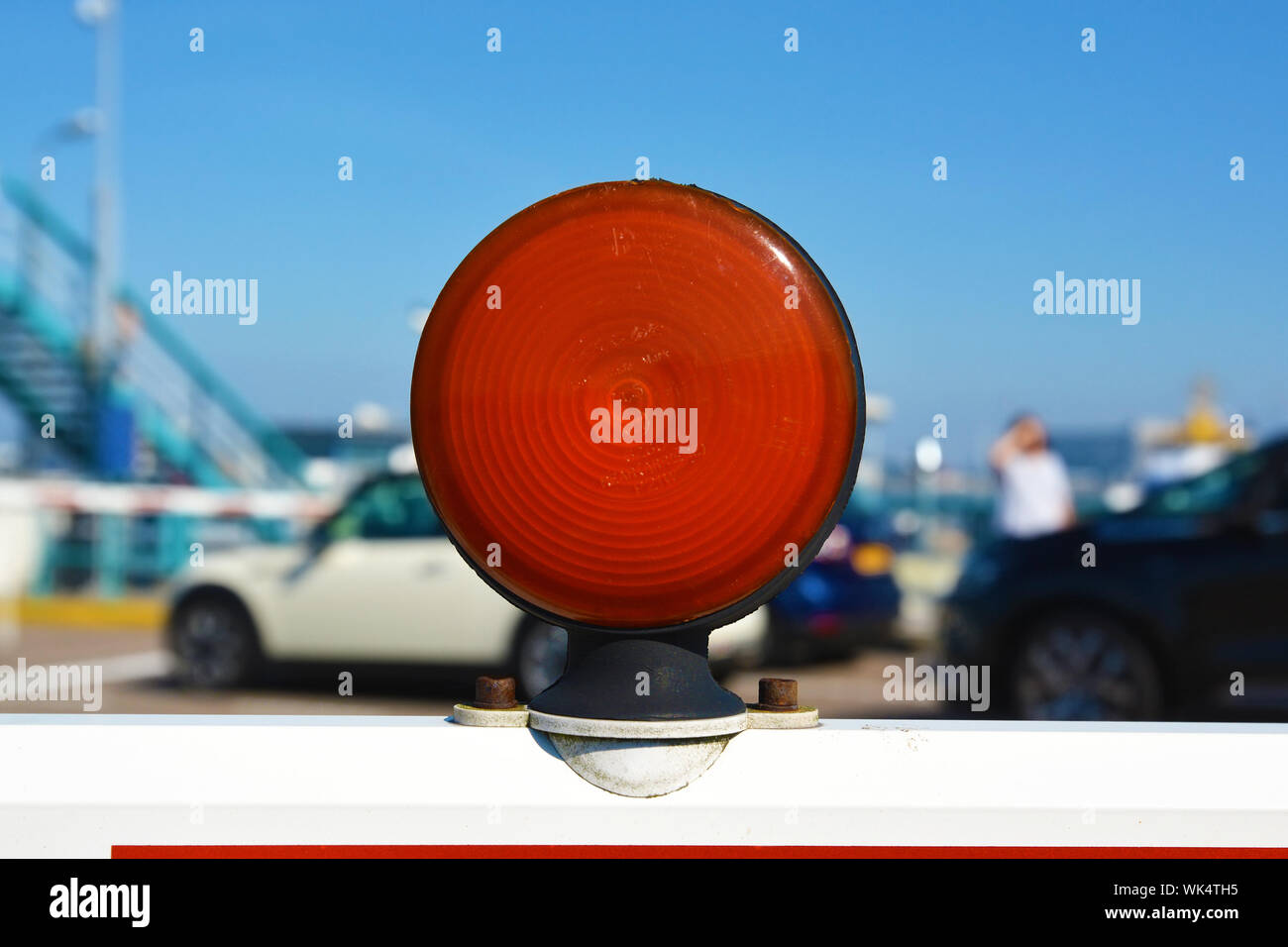 Red round traffic warning light on barrier in front of blue sky Stock ...