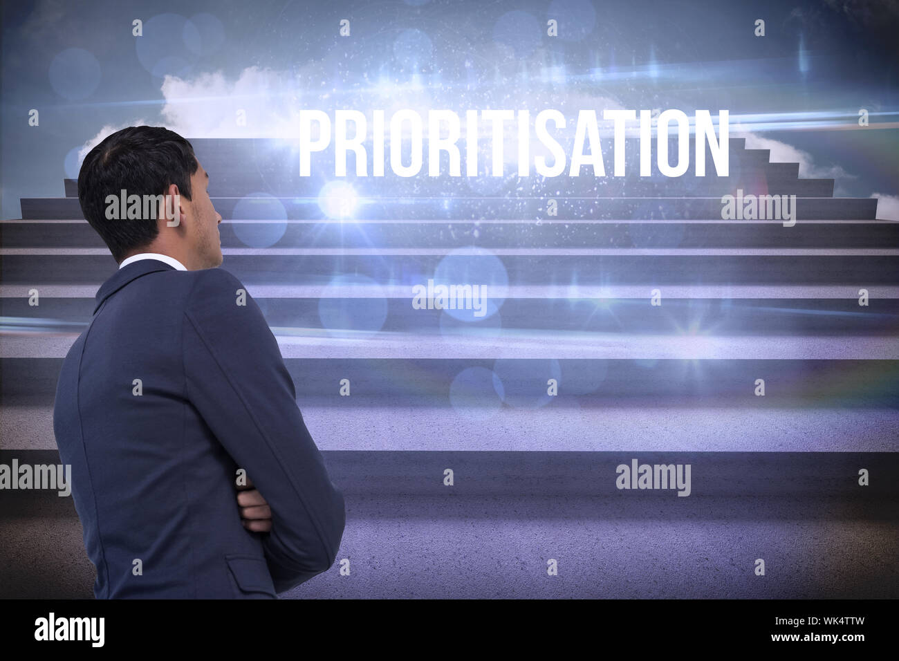 The word prioritisation and unsmiling asian businessman with arms ...