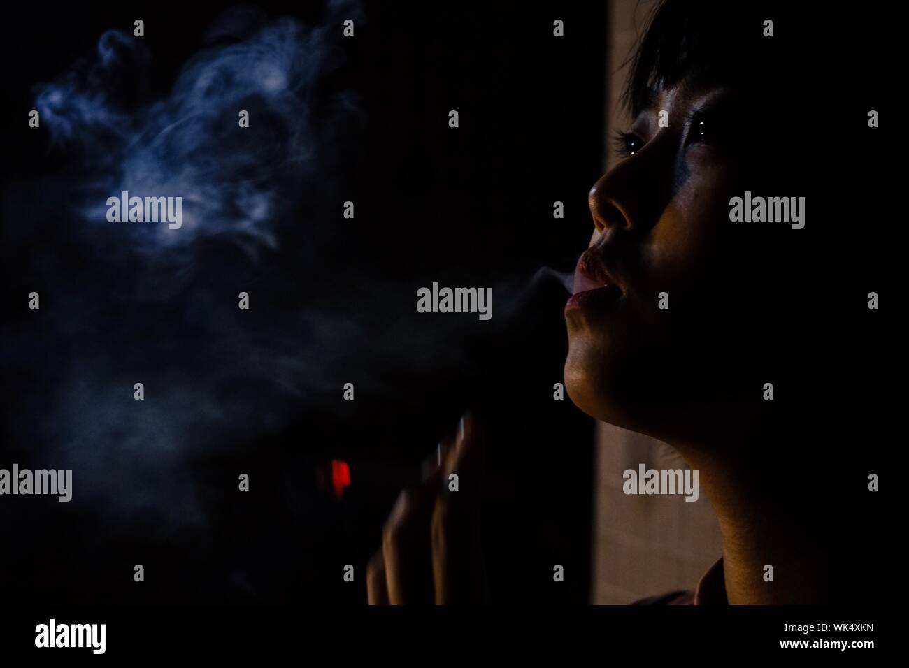 Woman exhaling smoke hi-res stock photography and images - Alamy