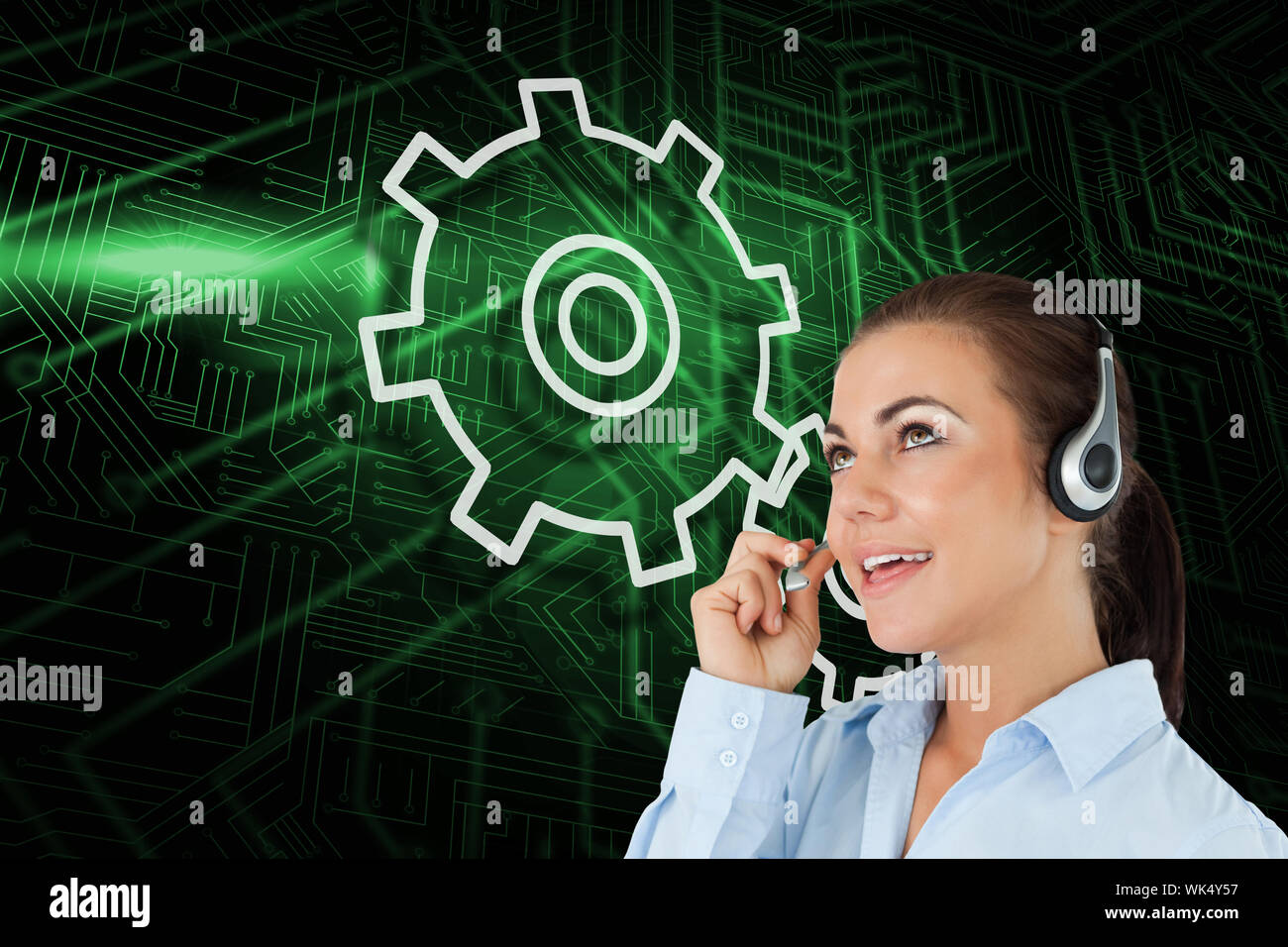Composite image of cog and wheel with call center worker against green ...