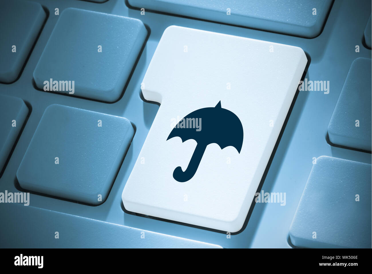 Umbrella against white enter key on keyboard Stock Photo - Alamy