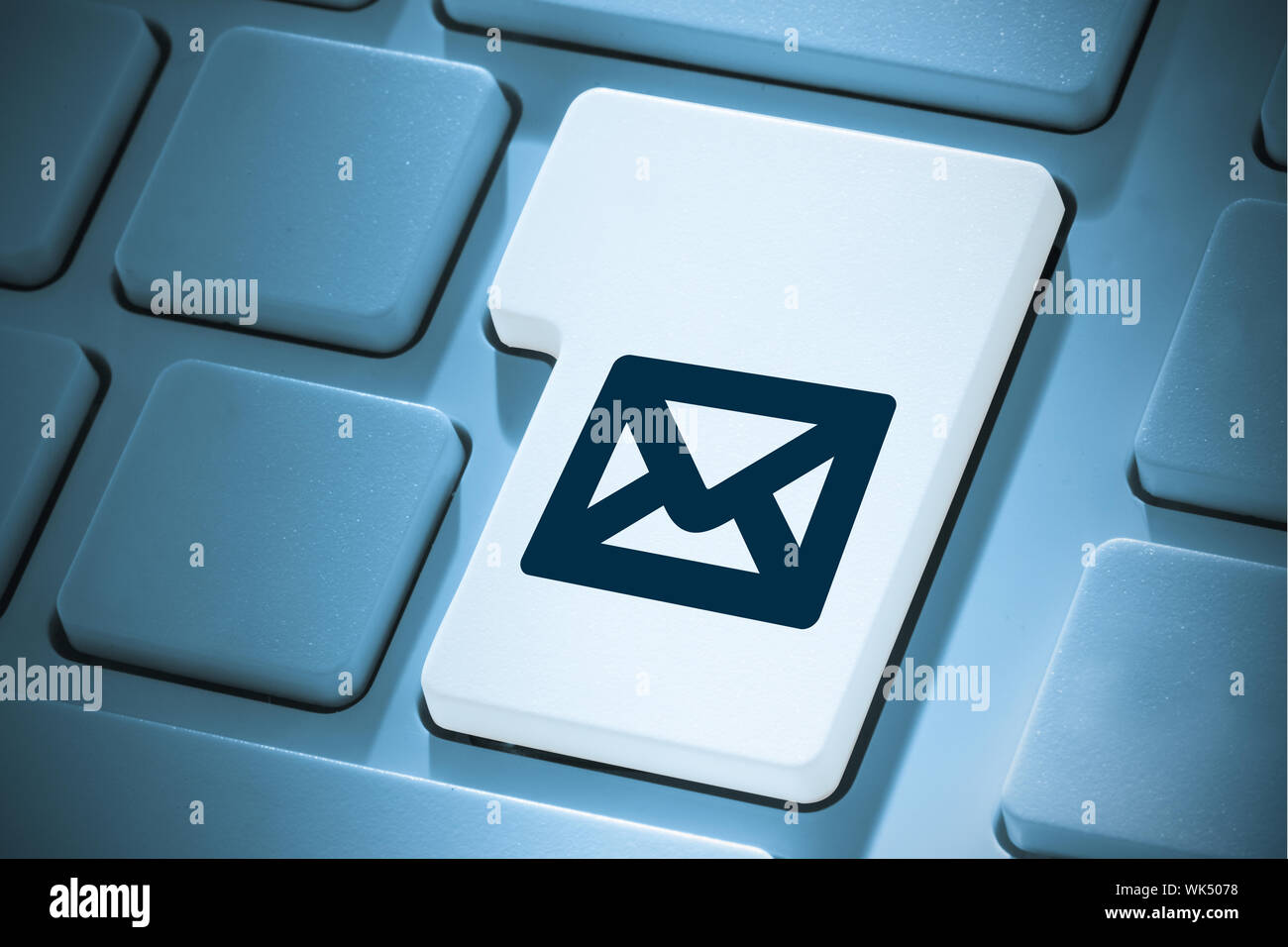 Envelope against white enter key on keyboard Stock Photo - Alamy