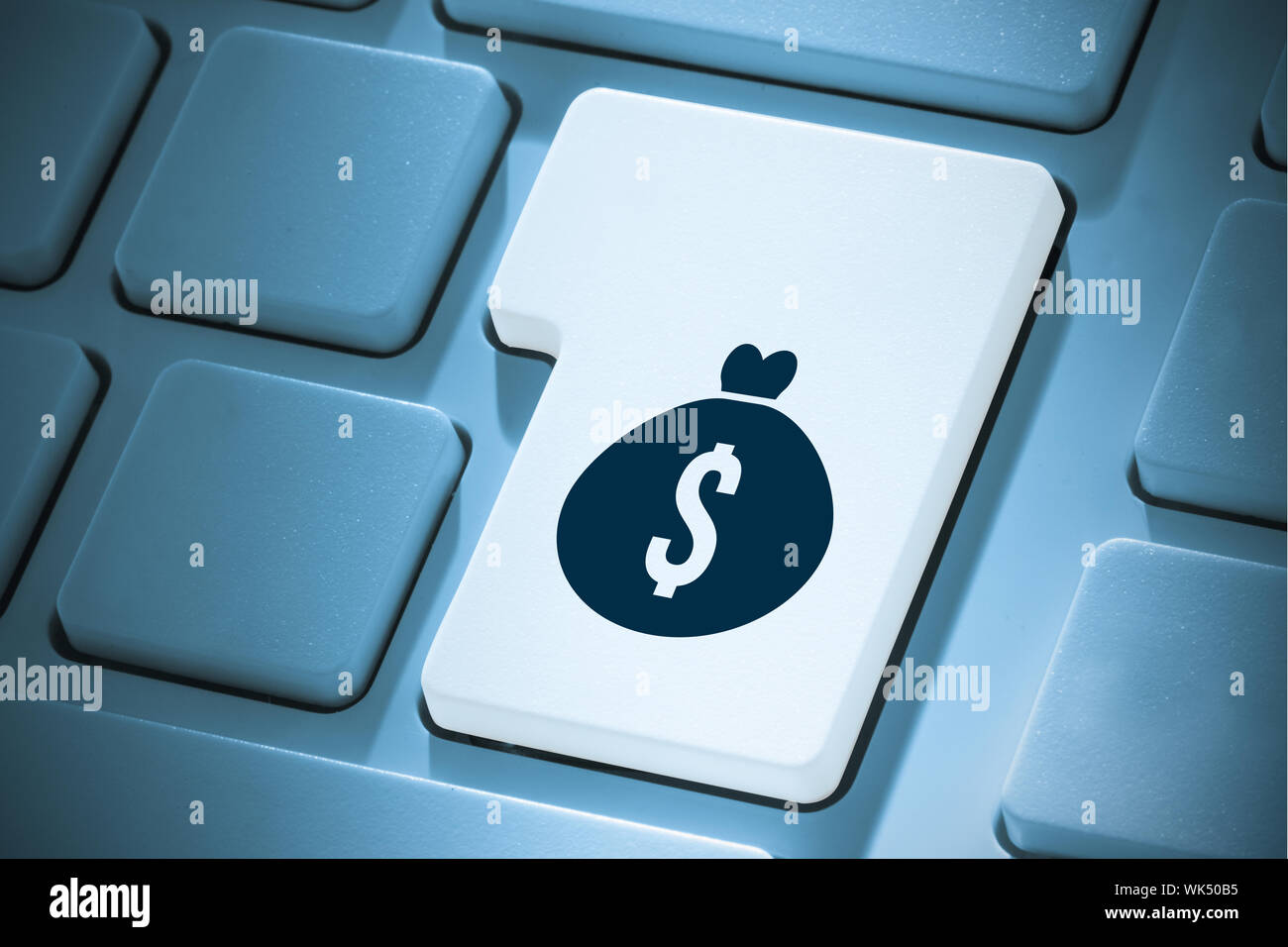 Money bag against white enter key on keyboard Stock Photo - Alamy