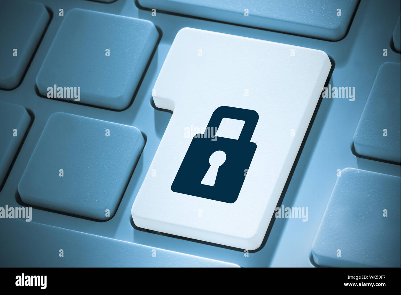 Lock against white enter key on keyboard Stock Photo - Alamy