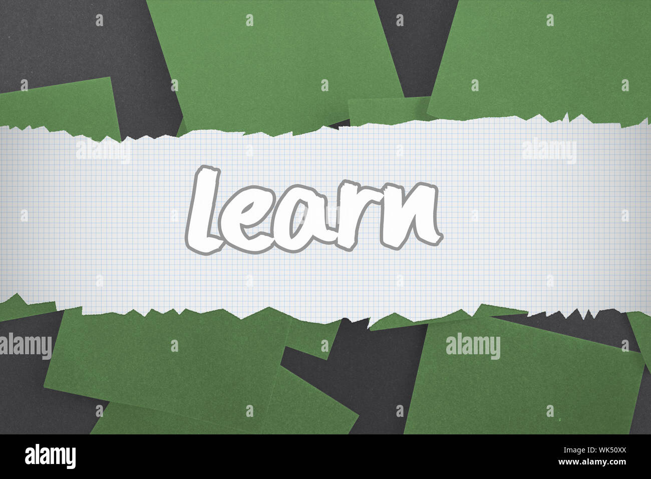 The word learn against green paper strewn over black Stock Photo - Alamy