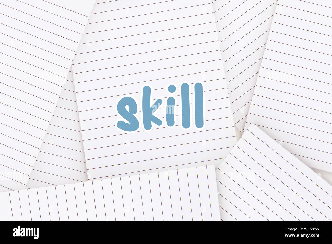 The word skill against lined paper strewn over surface Stock Photo - Alamy