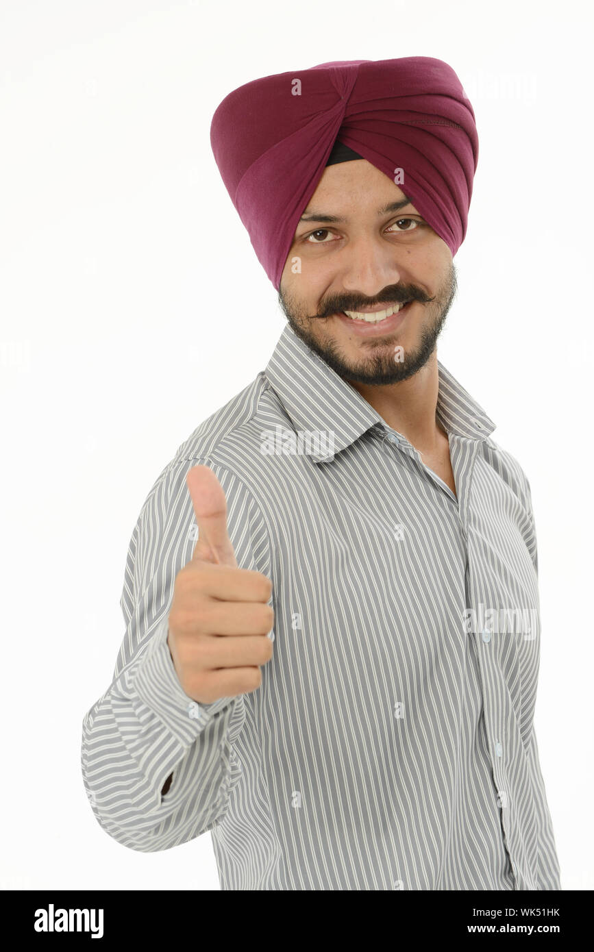 Indian young man showing thumbs up sign and smiling Stock Photo - Alamy