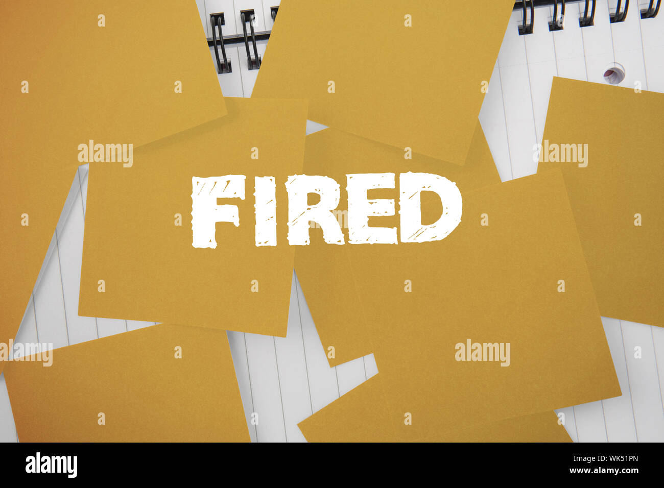 The word fired against yellow paper strewn over notepad Stock Photo - Alamy