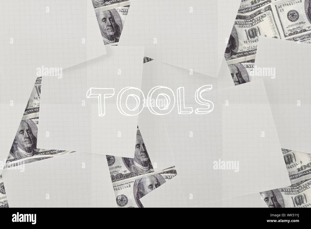 The word tools against white paper strewn over dollar bills Stock Photo ...