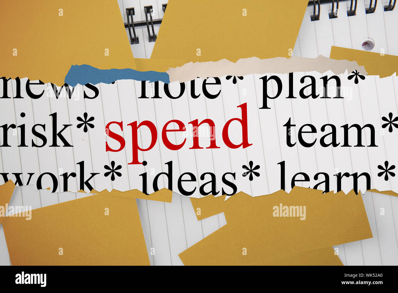 The word spend against yellow paper strewn over notepad Stock Photo - Alamy