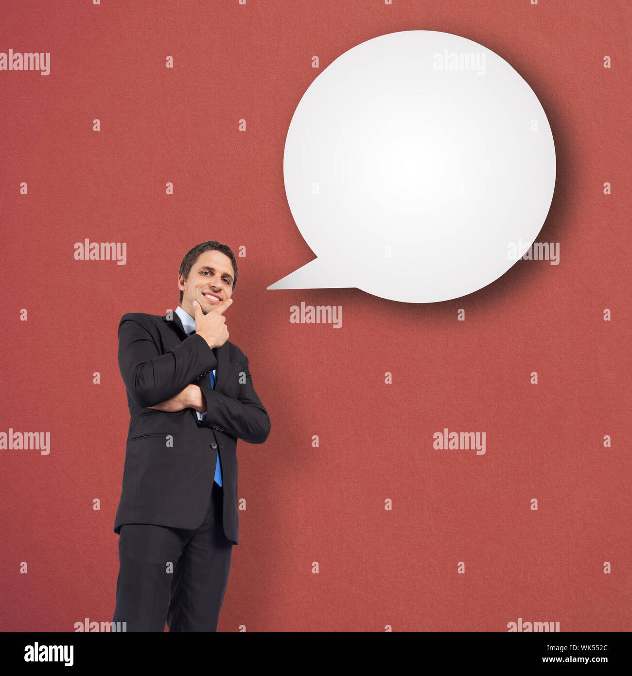 Thinking businessman touching his chin against bright white room with ...
