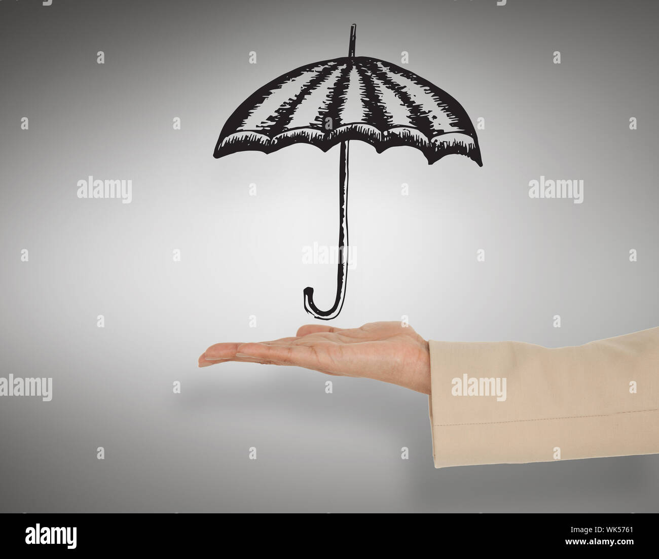 Female hand presenting umbrella against grey vignette Stock Photo - Alamy