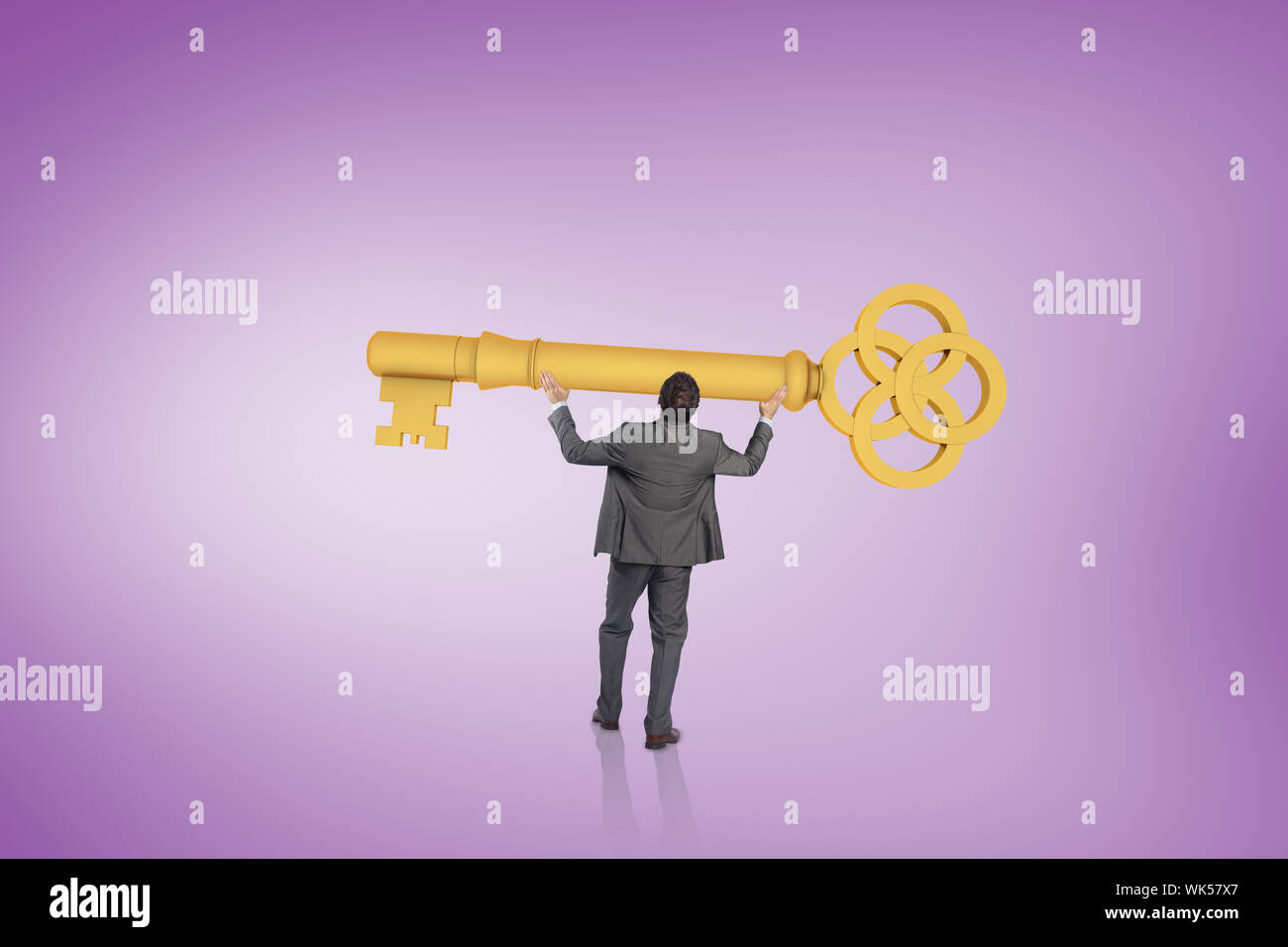 Businessman carrying large key with arms raised against purple vignette ...