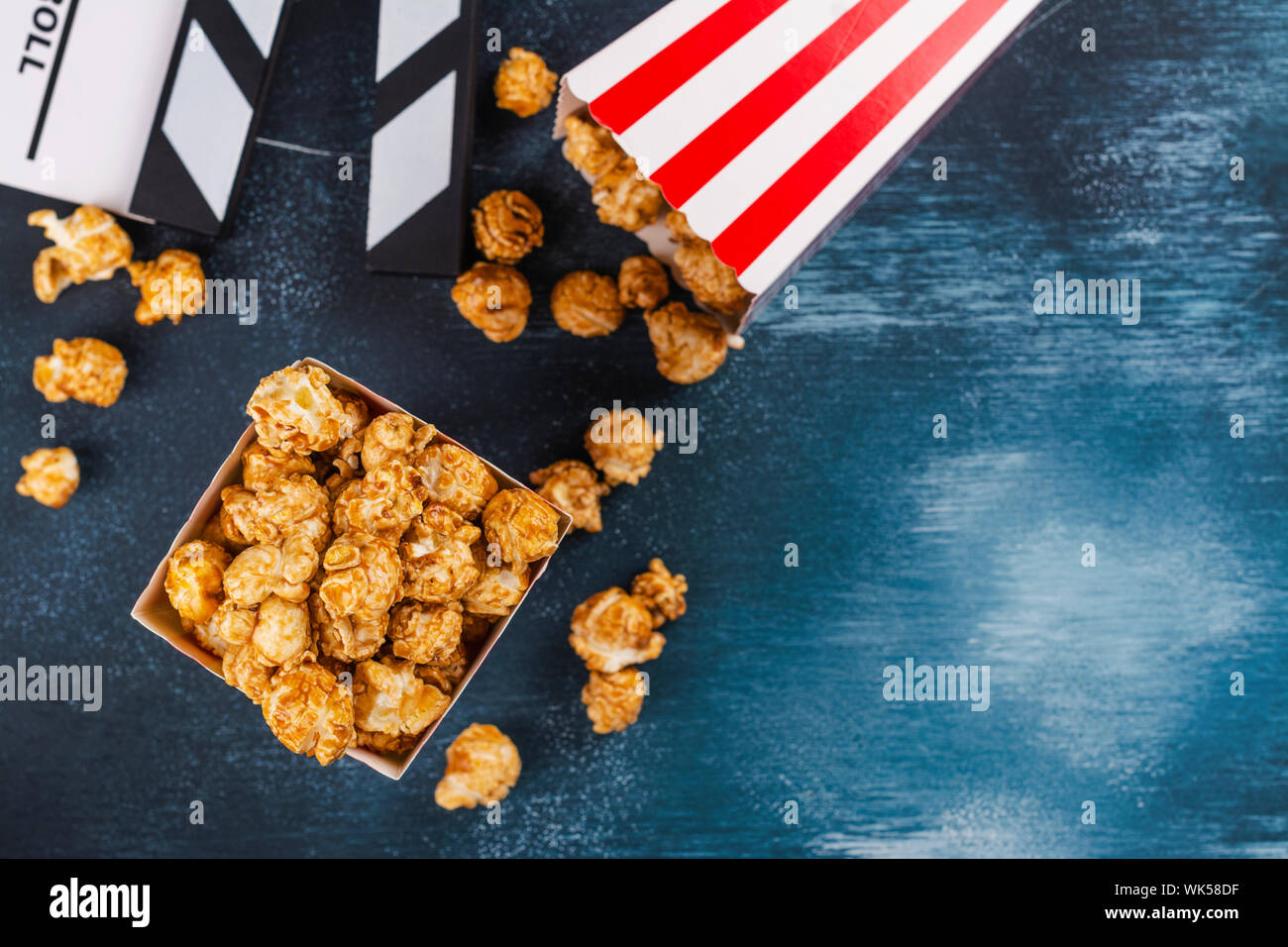 Caramel popcorn and wooden clapper Stock Photo - Alamy